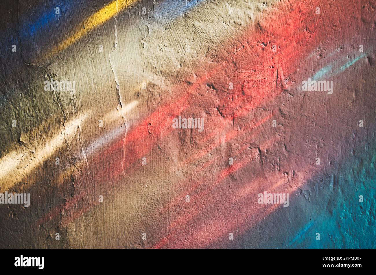 Colourful rays of light from a stained glass window shining on a church ...