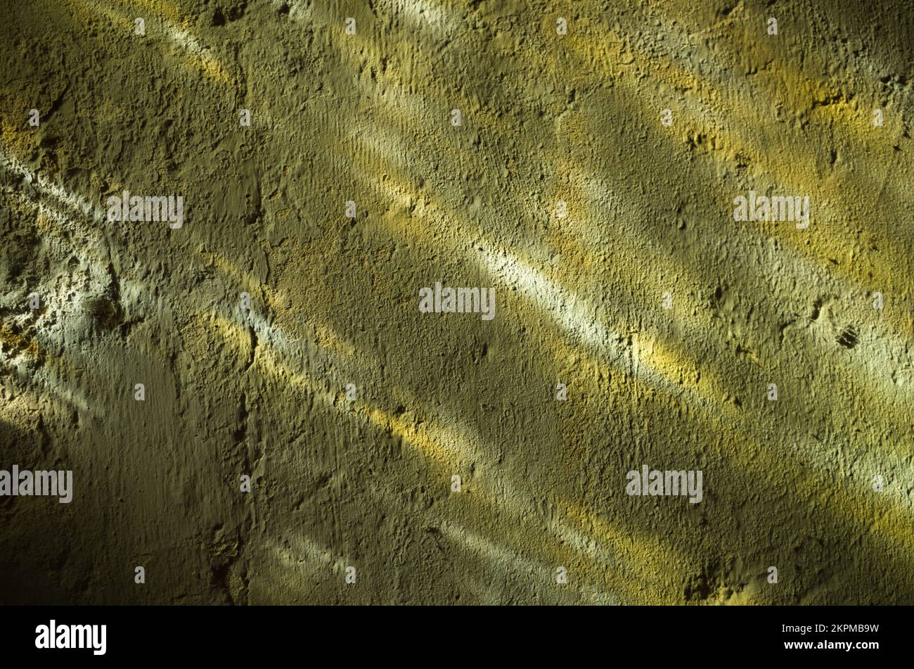 Golden rays of light from a stained glass window shining on a church ...