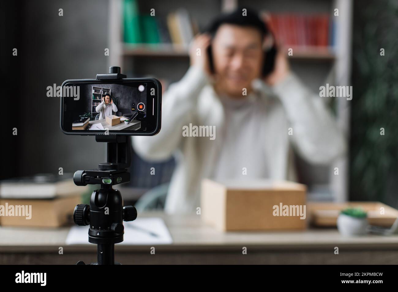 Focuse on smartphone screen, asian man recording video on phone camera ...