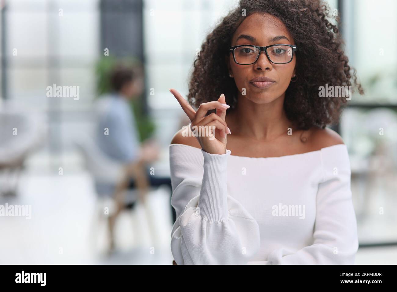 Portrait of african american young business woman showing finger ...