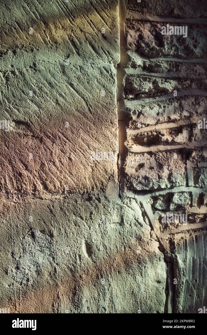 Colourful rays of light from a stained glass window on a Cotswold stone ...