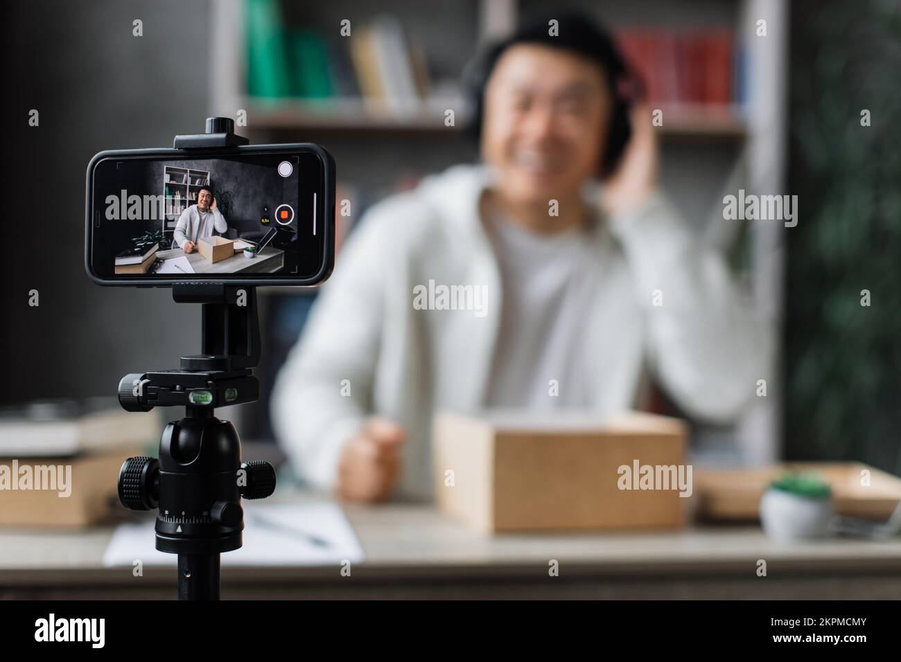 Focuse on smartphone screen, asian man recording video on phone camera ...
