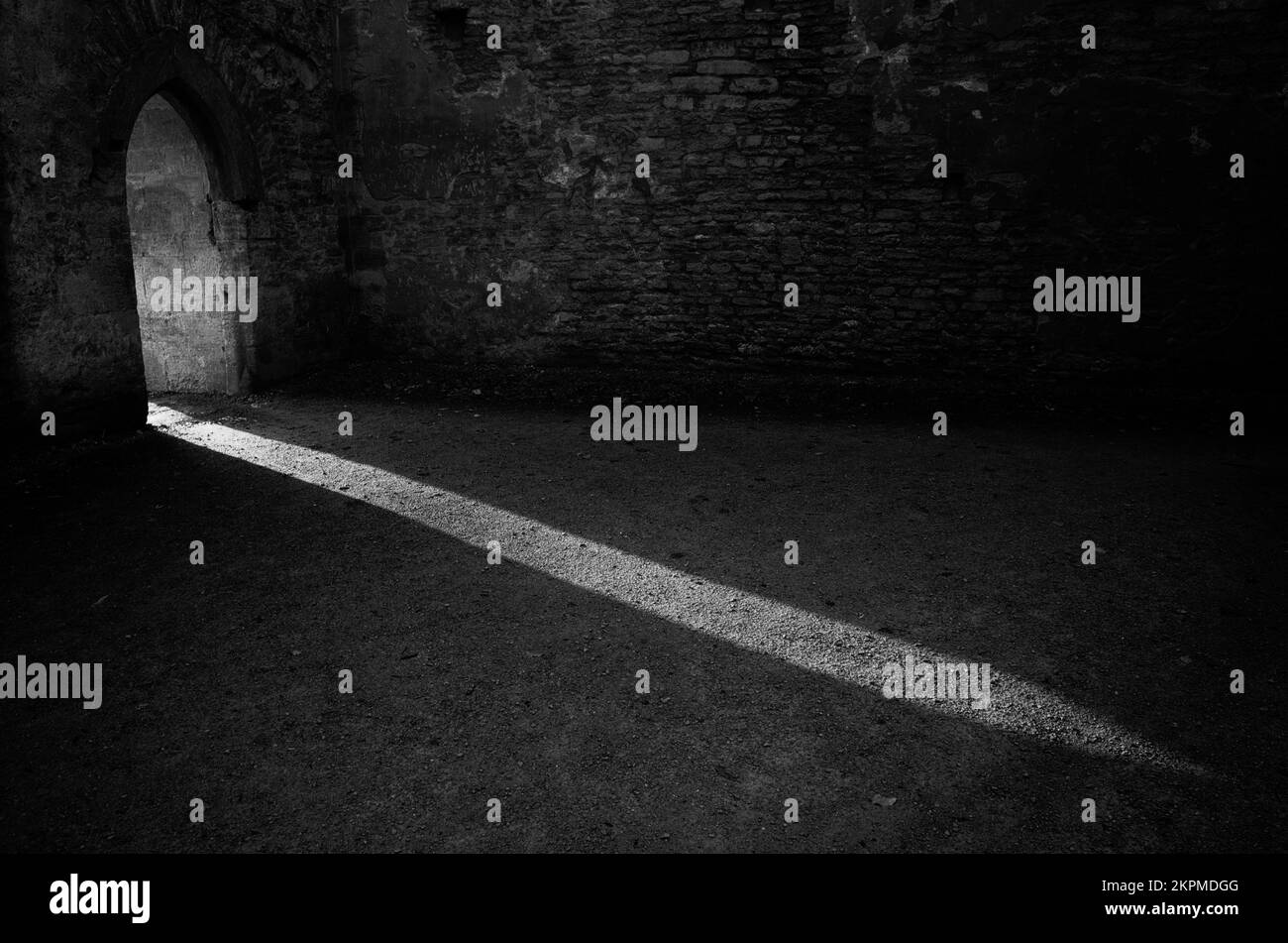 Black and white image of a ray of light shining through an arch Stock ...