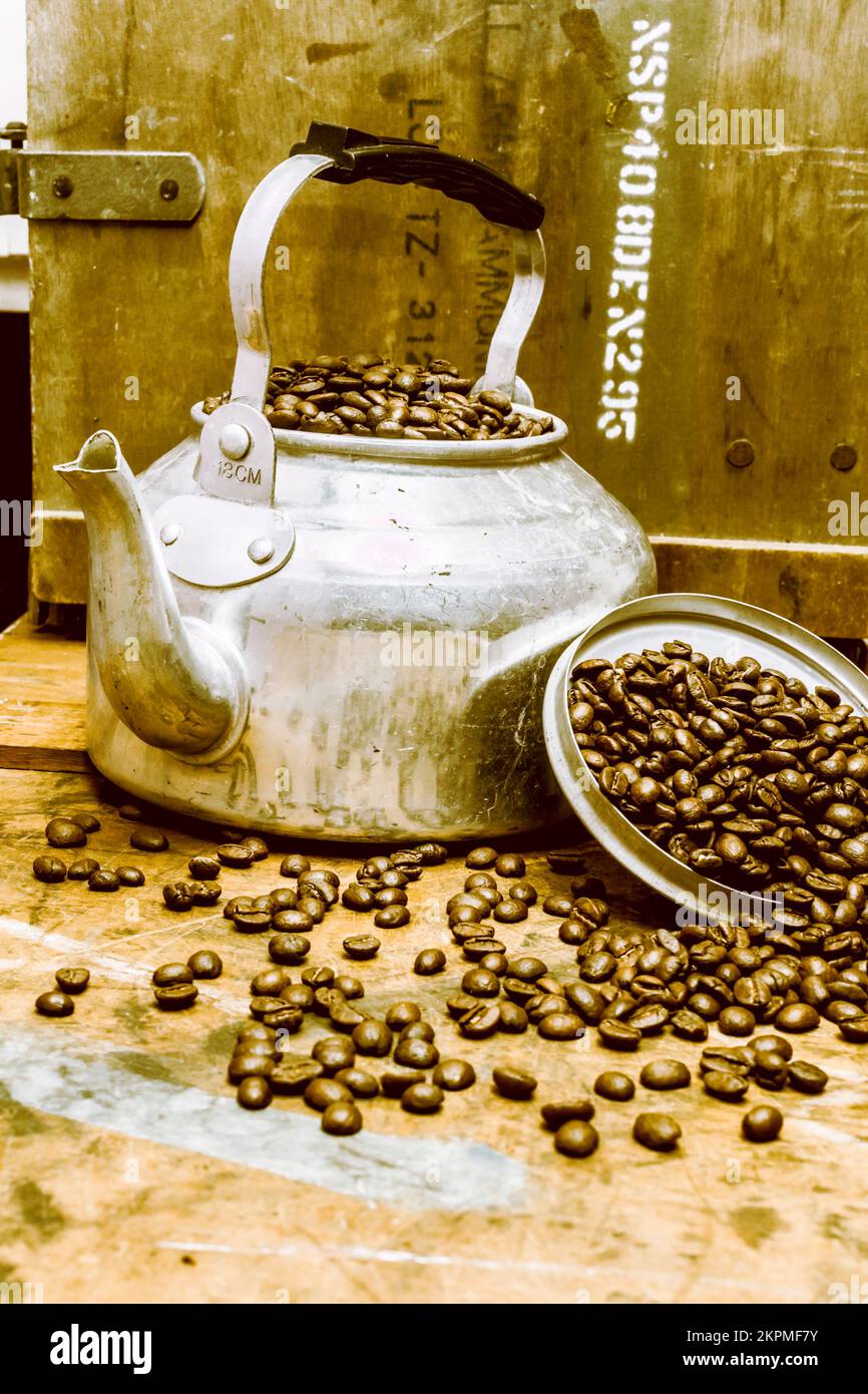 Antique wooden kitchen decoration of a vintage kettle in a spill of ...