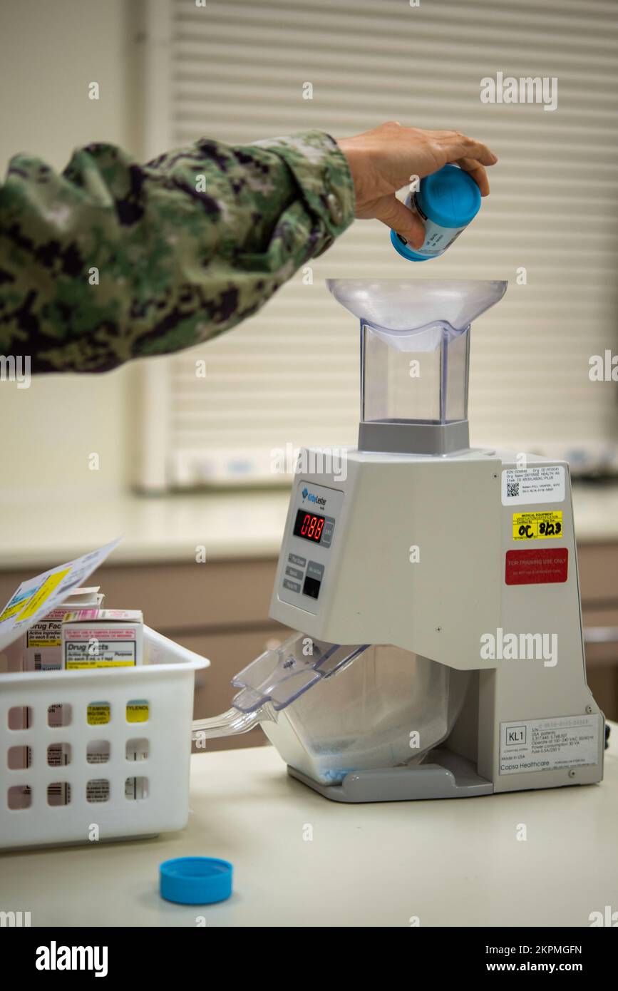 Students utilize an automated pill counter to fill prescription orders ...