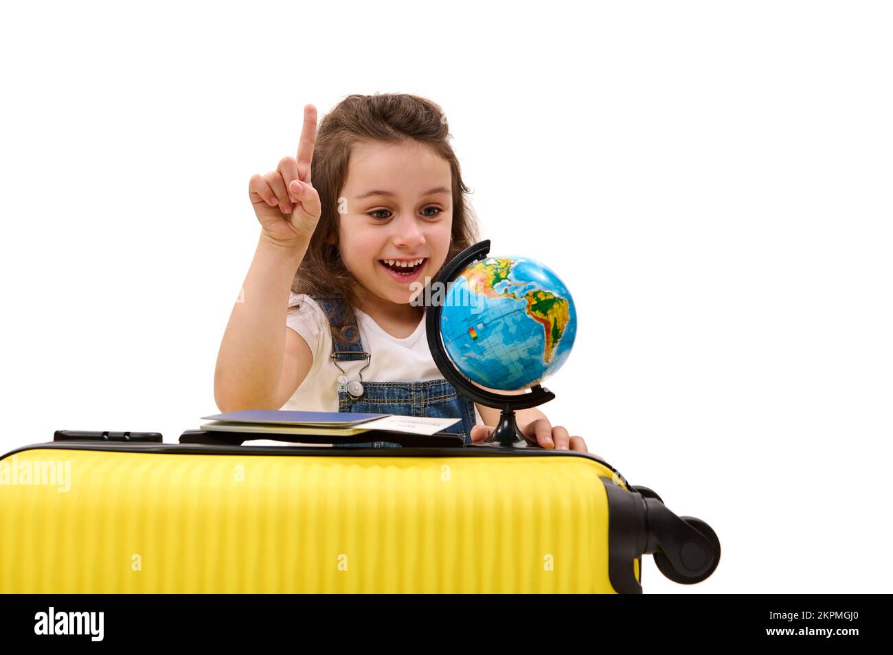 Cute baby girl with boarding pass and yellow suitcase going on summer ...