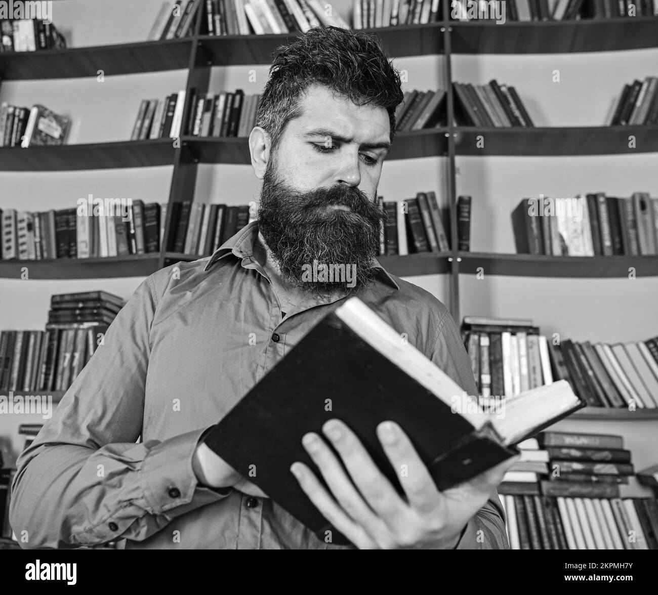 Young man beard reading book Black and White Stock Photos & Images - Alamy