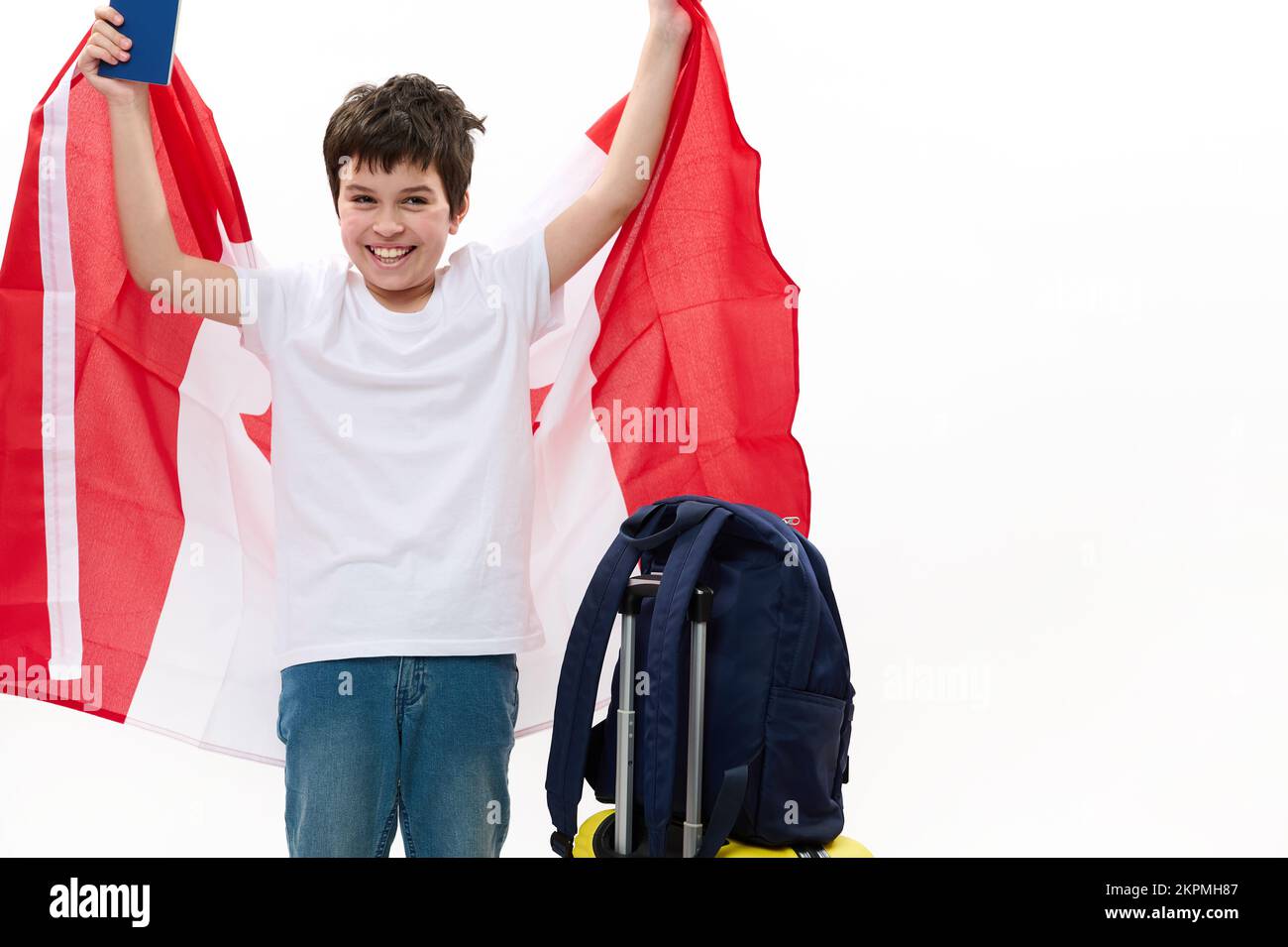 Overjoyed American teenage boy with Canadian flag, boarding pass and ...