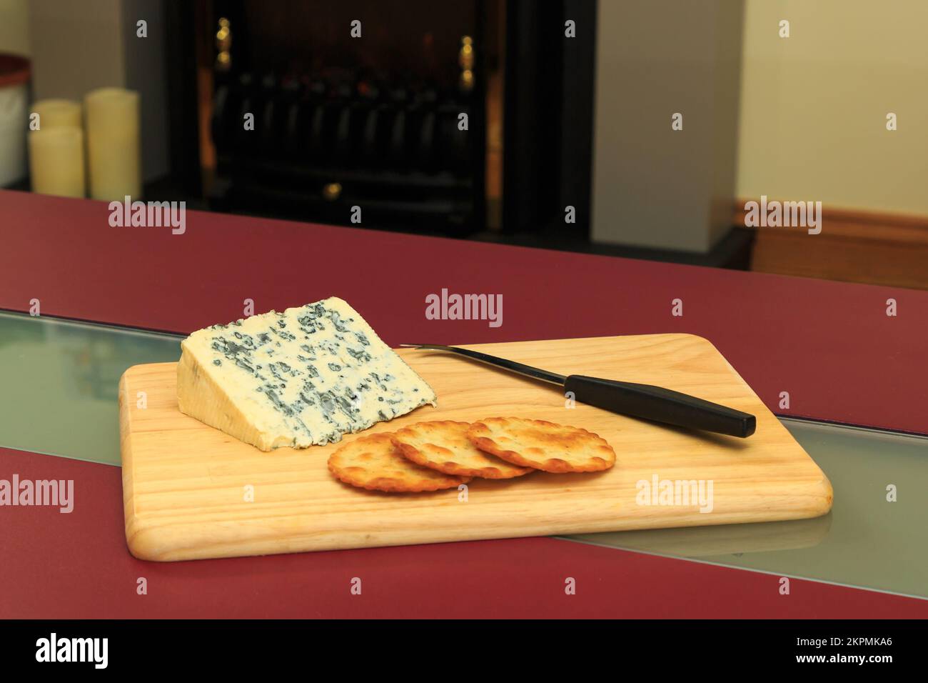 Low angel view of a portion of Blue cheese, knife and biscuits on a ...