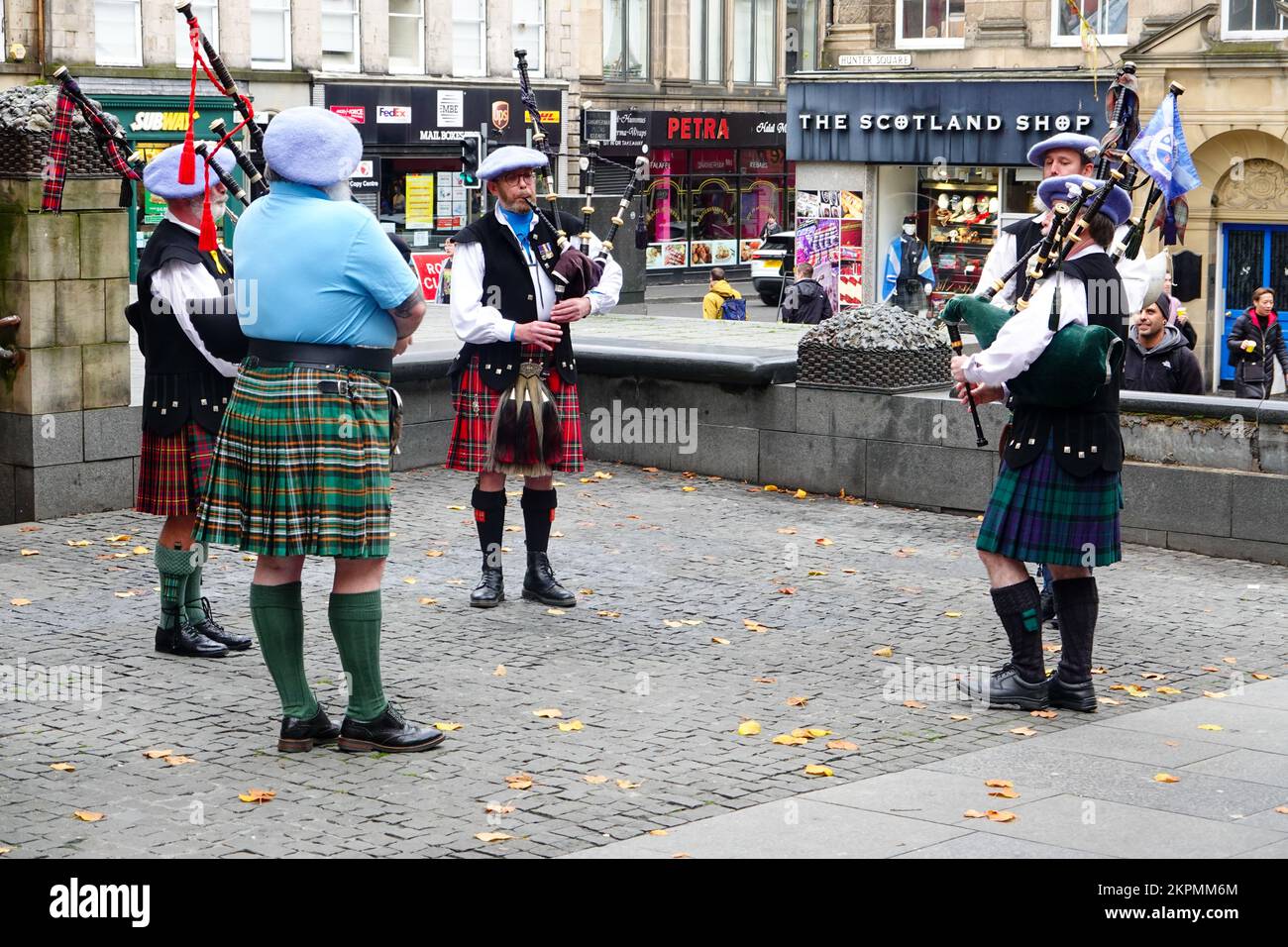 Onlookers watching bagpipers in traditional kilts performing in Hunter ...
