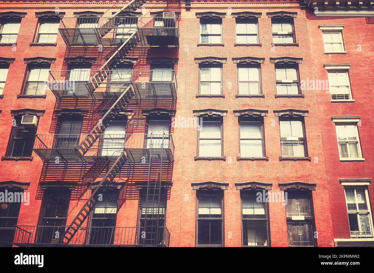 Old townhouse building with iron fire escape, color toning applied, New ...