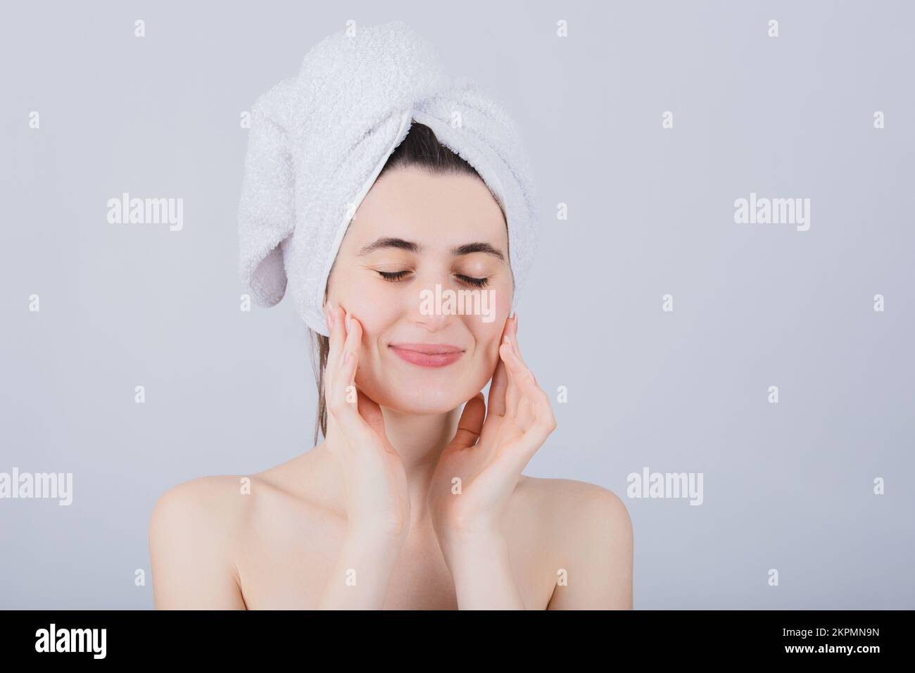 Young Woman With Towel On Head Smiling and enjoying a refreshing ...
