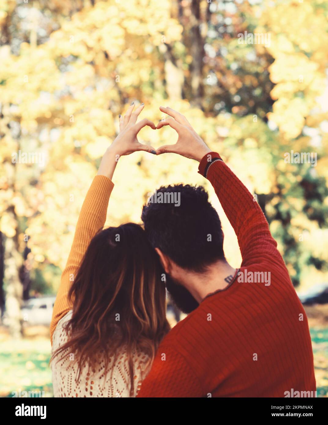 Man and woman turned backwards on autumn trees background Stock Photo ...