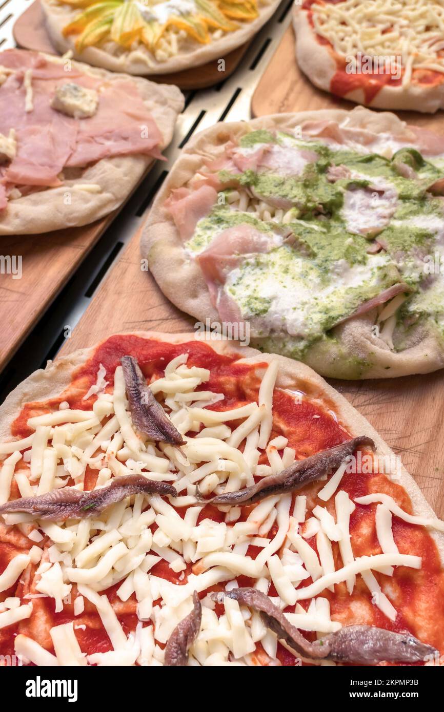 Variety of raw pizzas to bake. Restaurant. Pizzeria. Italian food Stock ...