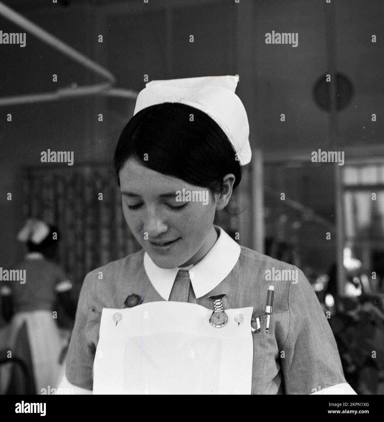 1969, historical, inside a hospital ward, a young female NHS nurse ...