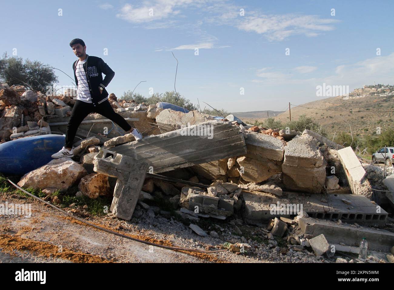 Palestinian inspects a destroyed house demolished by the Israeli army ...