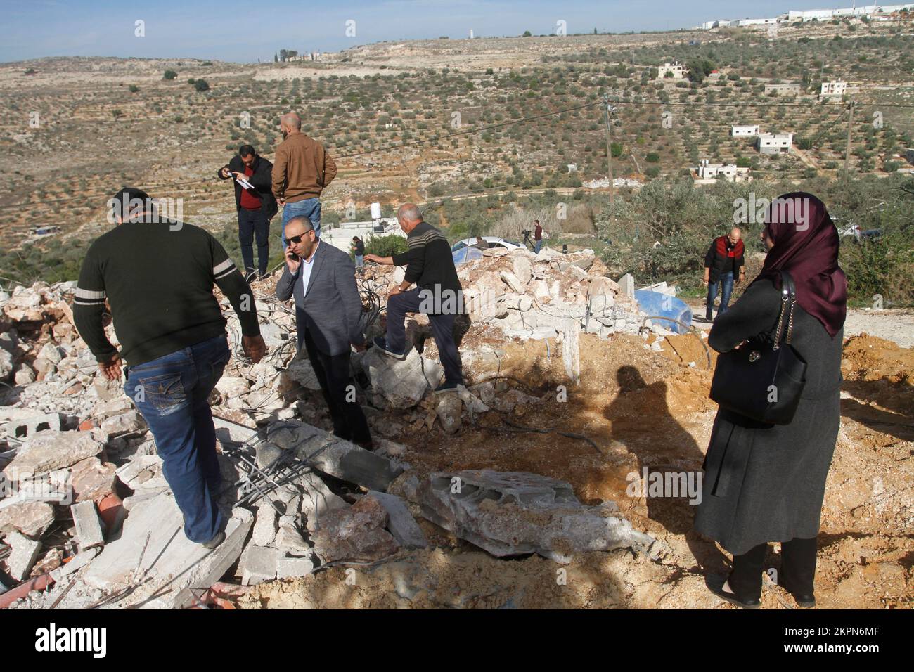 Palestinians inspect a destroyed house demolished by the Israeli army ...