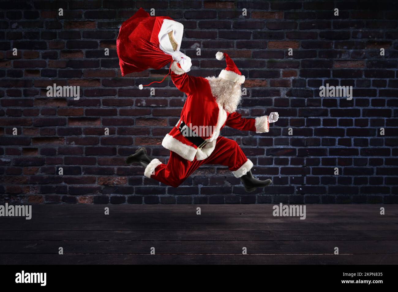 santa claus runs fast to deliver all gifts for christmas Stock Photo - Alamy