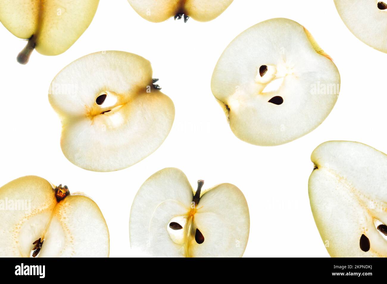 Backlit apple and pear slices. Sliced fruits on a white background ...