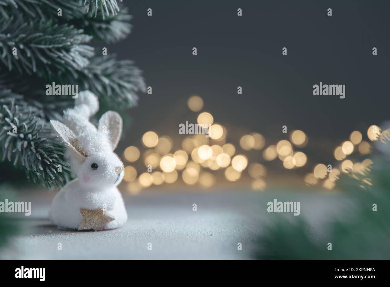 a rabbit symbol of 2023 among the lights, garlands, Christmas trees ...