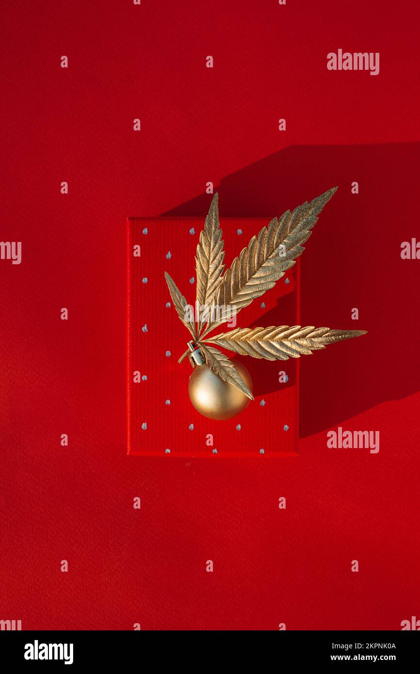 Festive red christmas background with golden marijuana leaf and gift ...
