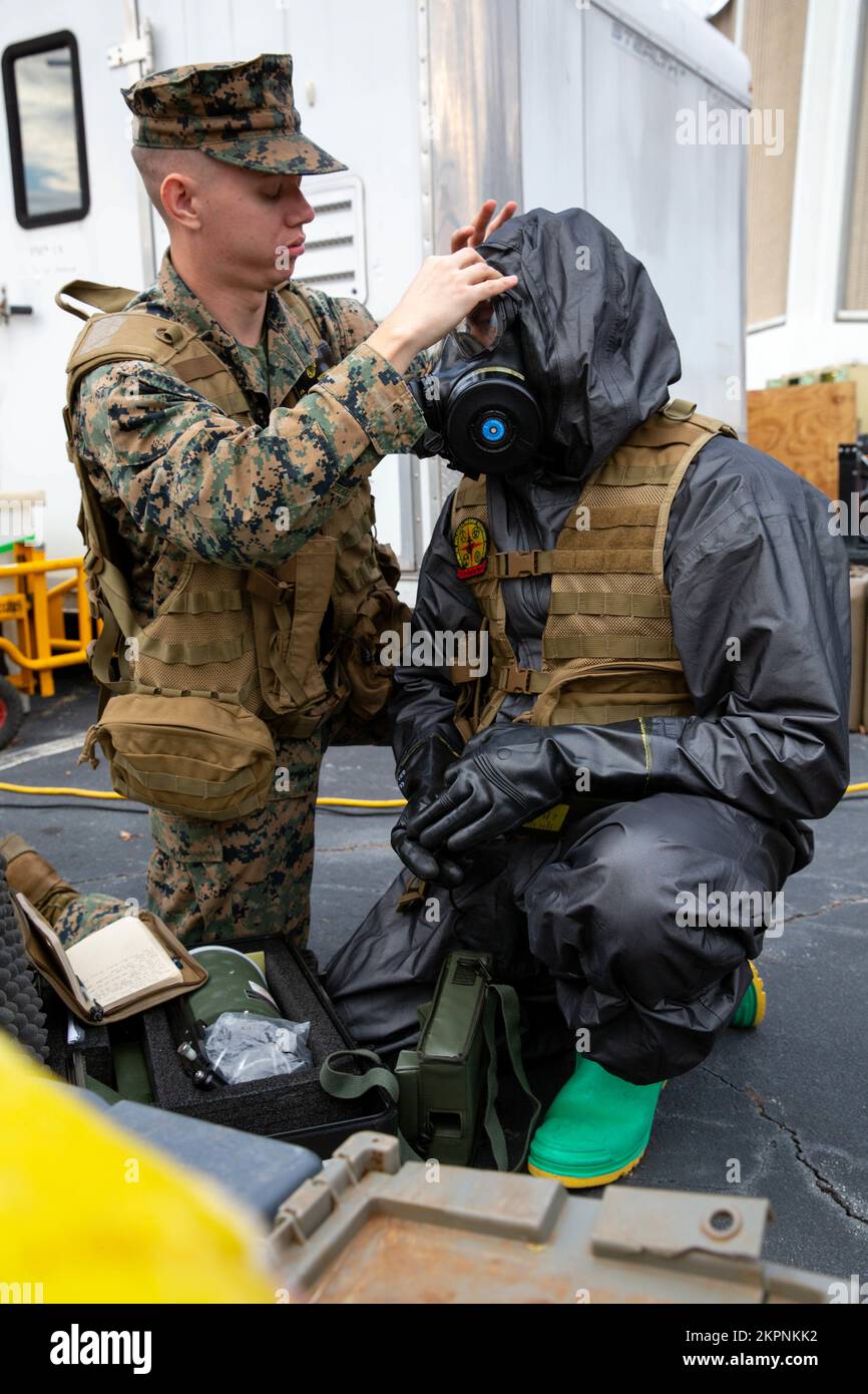 U.S. Marine Cpl. Joshua Nottingham assists Sgt. David McMillin both ...