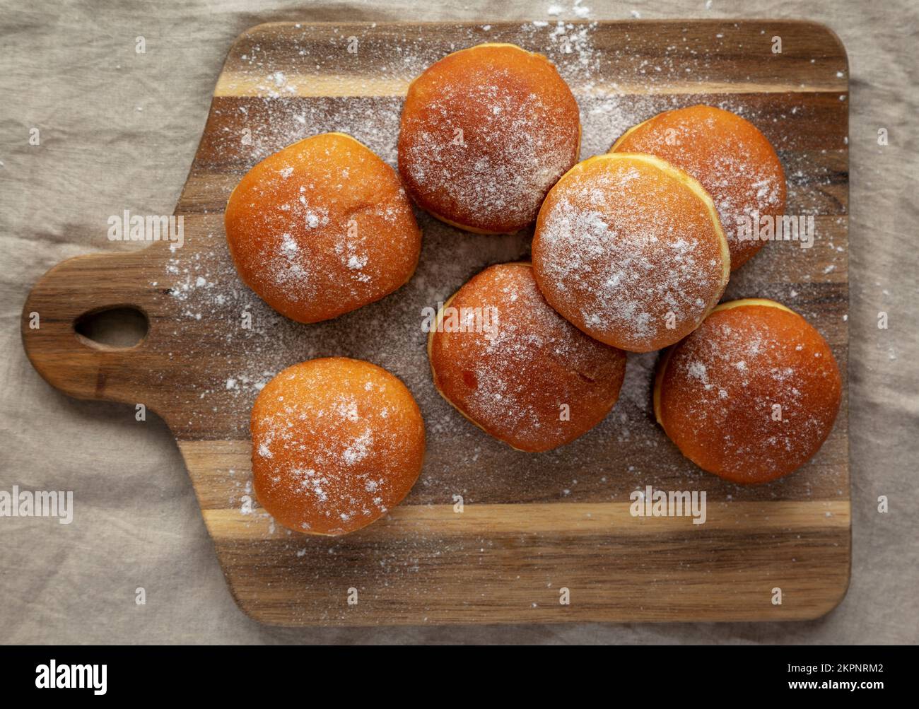 Homemade Apricot Polish Paczki Donut with Powdered Sugar on a Wooden ...