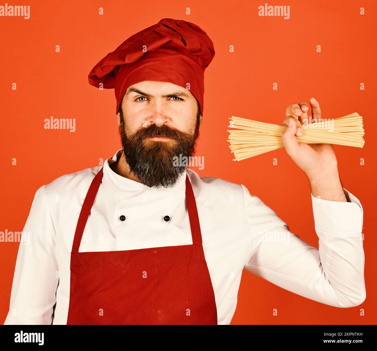 Italian cuisine concept. Chef with bunch of spaghetti Stock Photo - Alamy