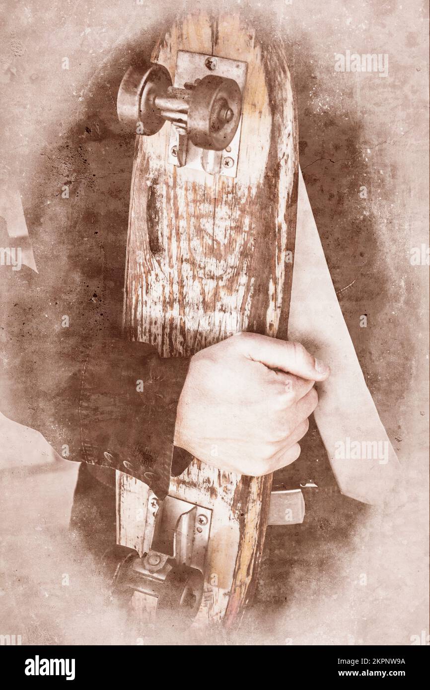 Old stylized photo with vignette texture on the hands of a skater man ...