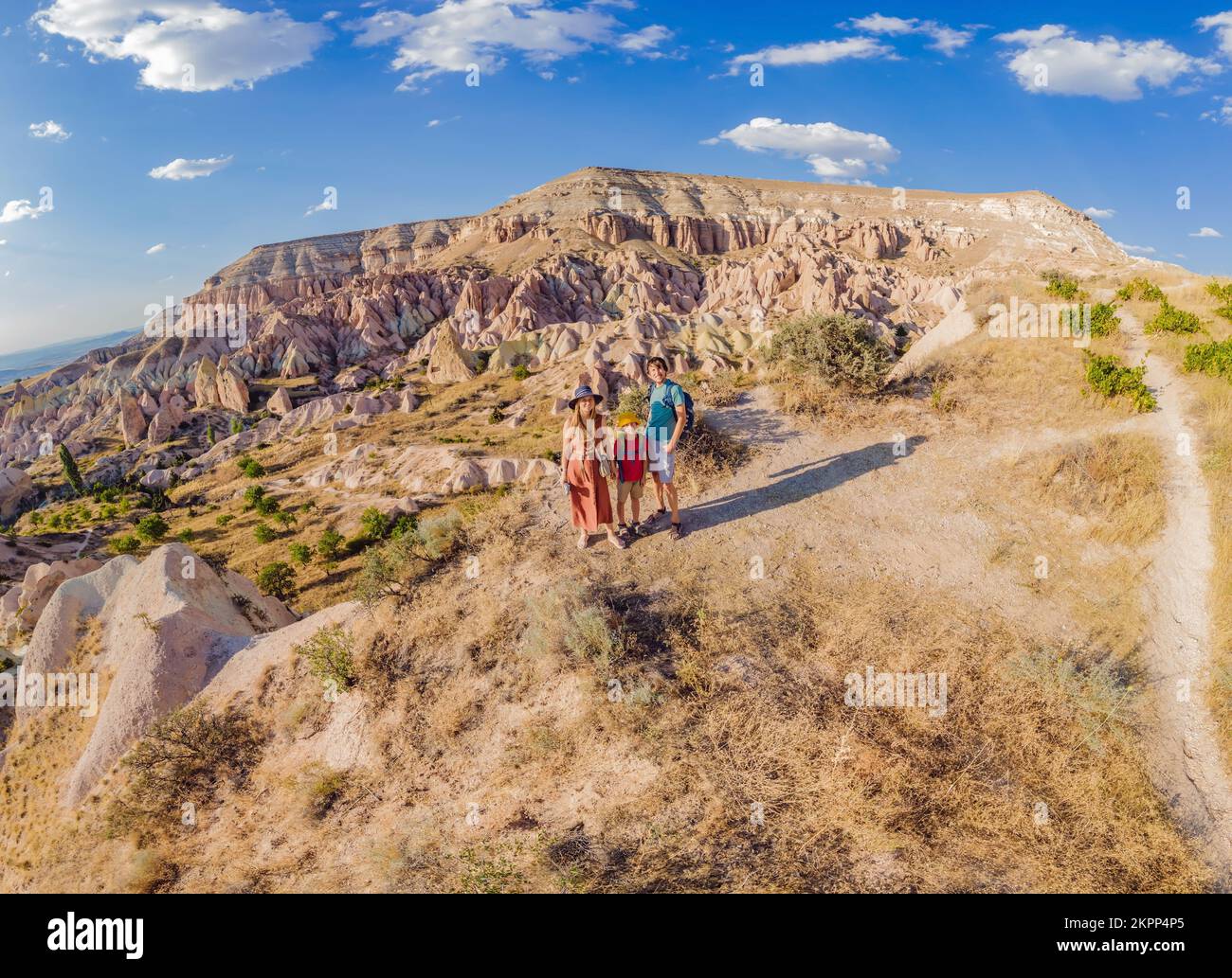 Happy family mother, father and son tourists exploring valley with rock ...