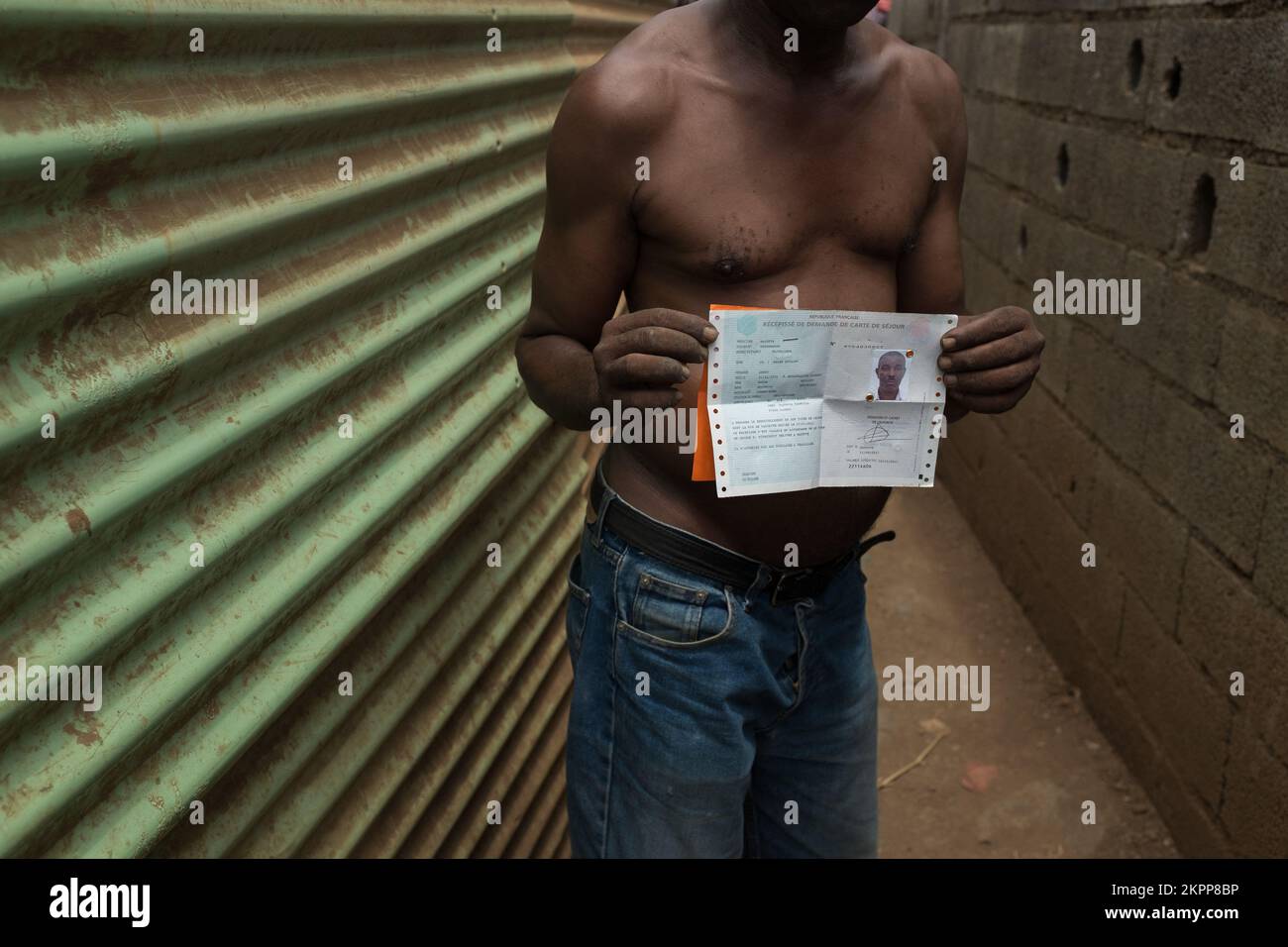 An illegal immigrant showing his papers (recipissé) in Mayotte, French ...