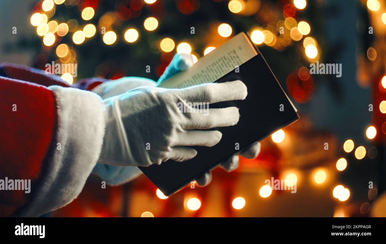 Santa Claus reads a book under the tree Stock Photo - Alamy