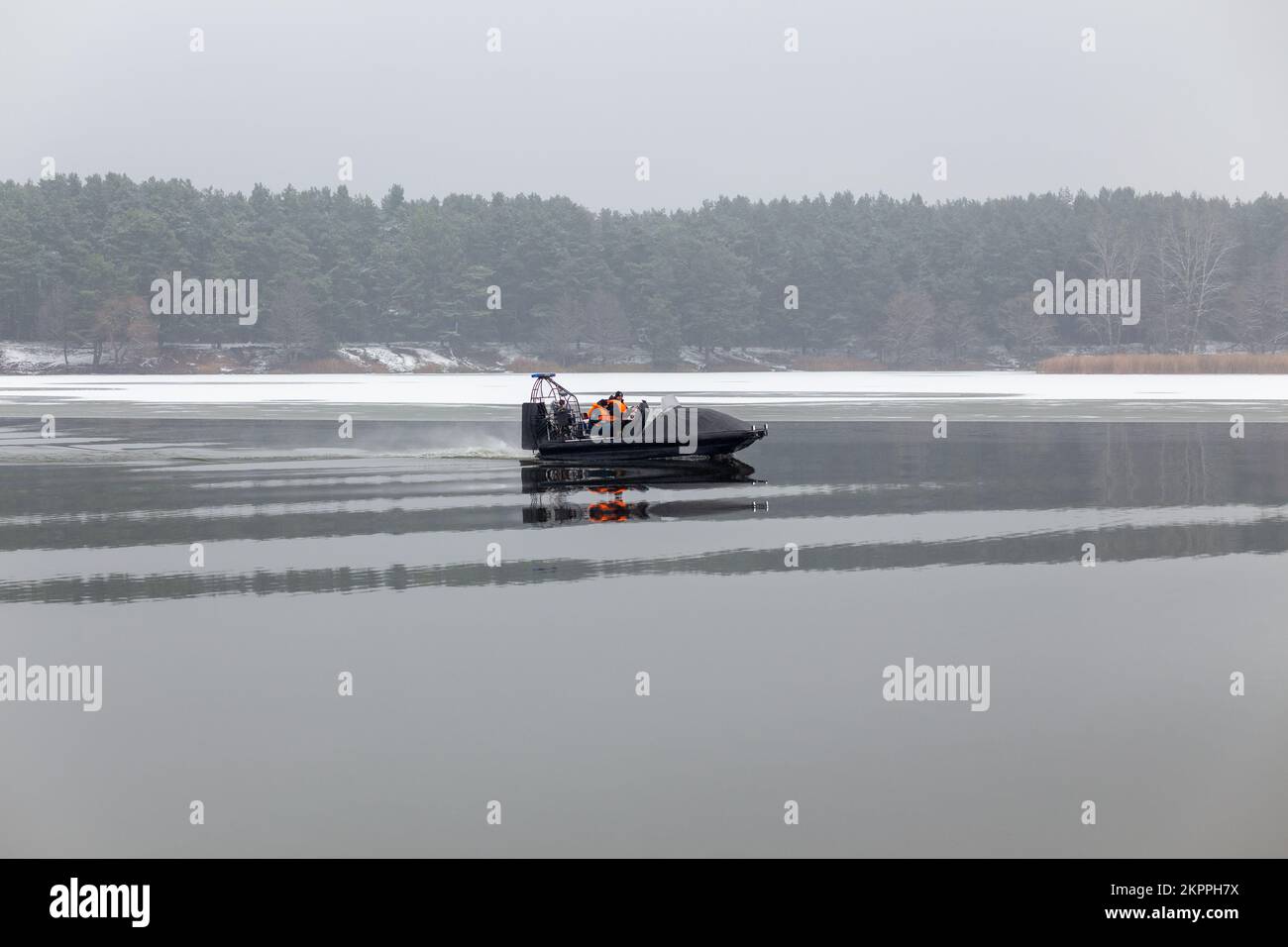A rescue team is sailing on a hovercraft to rescue fishermen on the ...