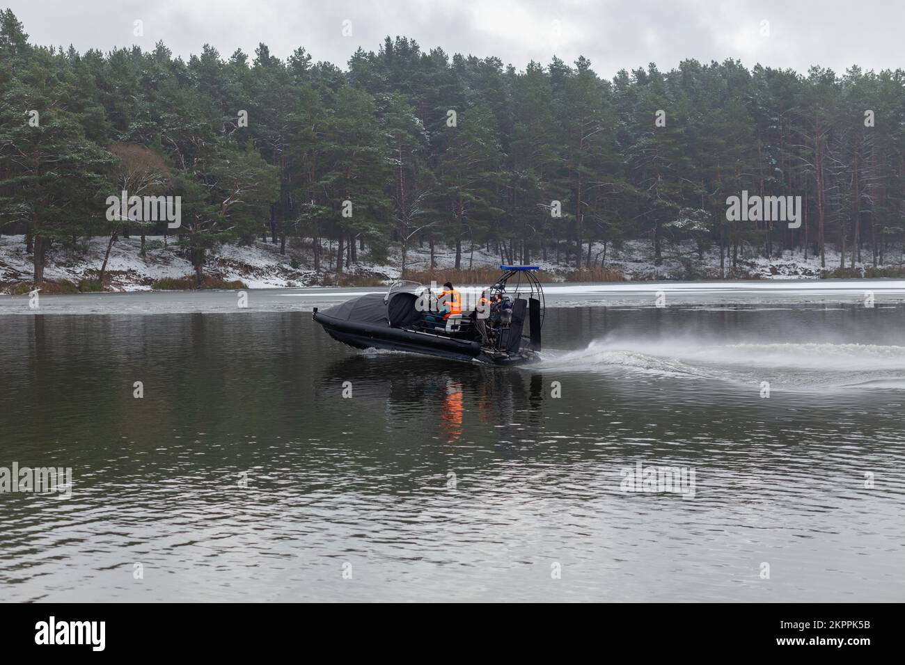 A rescue team is sailing on a hovercraft to rescue fishermen on the ...