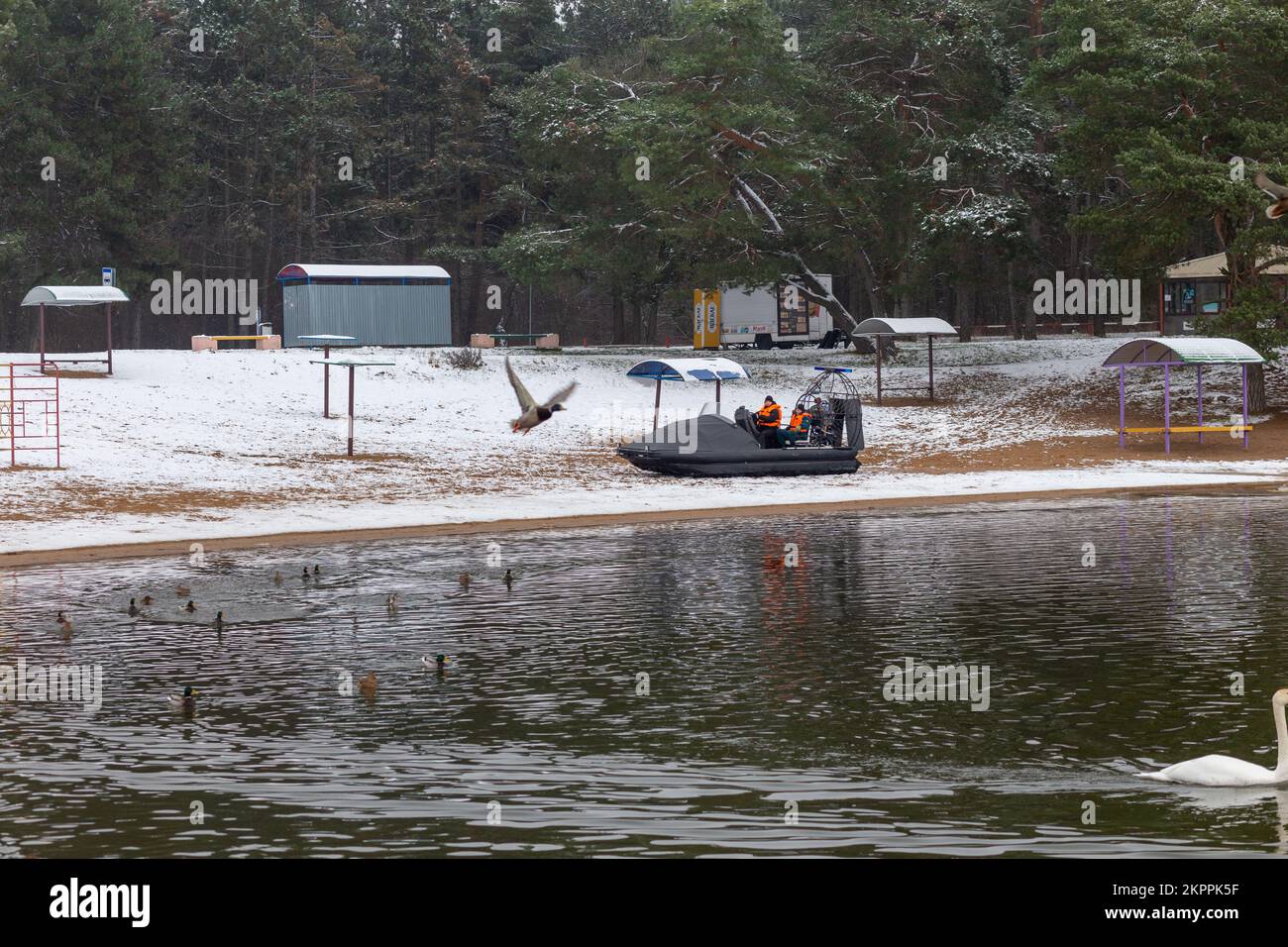 A rescue team is moving on a hovercraft on the sand beach at winter ...