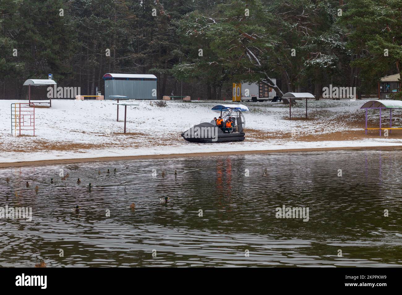 A rescue team is moving on a hovercraft on the sand beach at winter ...