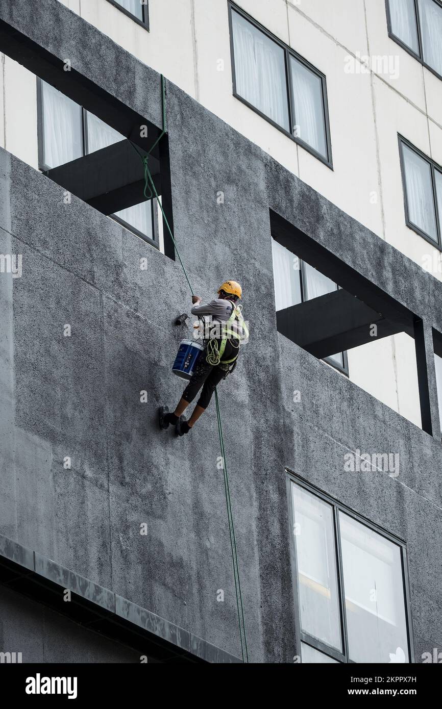 Climbing and painting a skyscraper Stock Photo - Alamy
