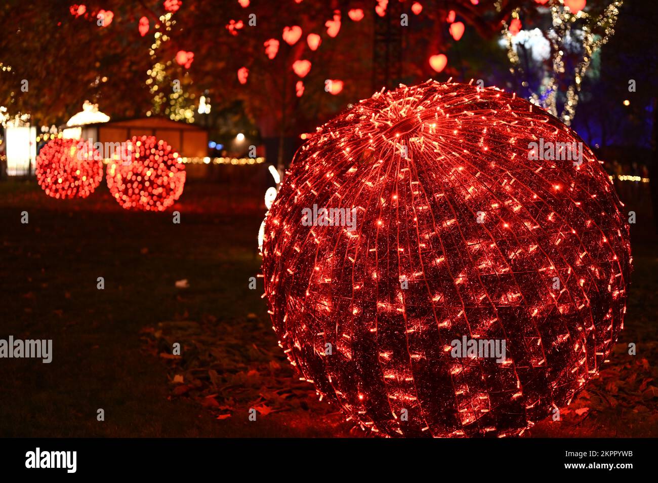 Big red shiny ball Christmas decorations in the park Rathaus Vienna ...