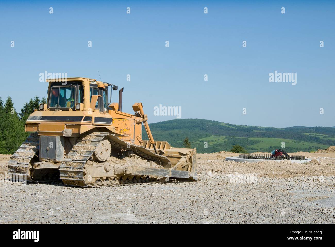 Wind power plant construction and yellow bulldozer Stock Photo - Alamy