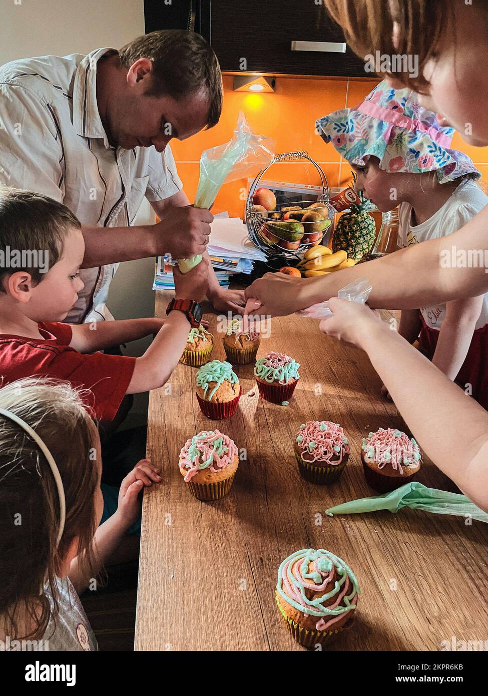Children decorating cupcakes together hi-res stock photography and ...