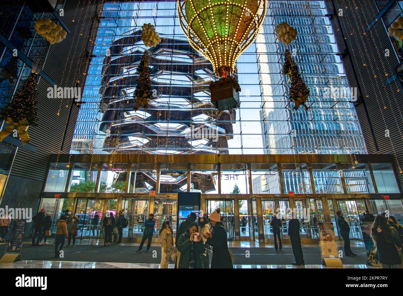 New York, NY – USA – Nov 20, 2022 View of tourists enjoying the decorated lobby of Hudson Yards ...