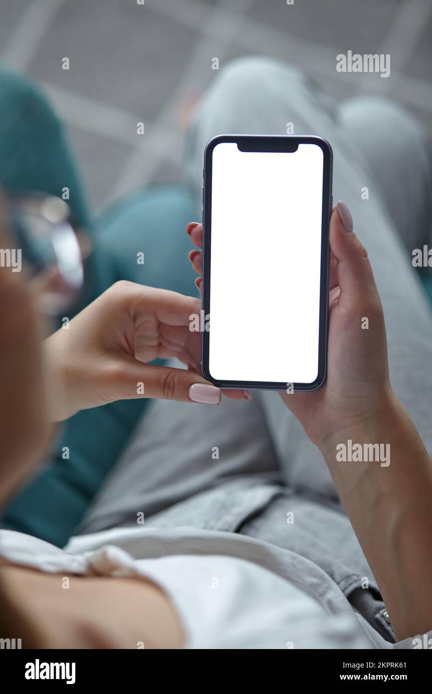 Mock up white screen blank close up mobile phone in woman hands holding ...
