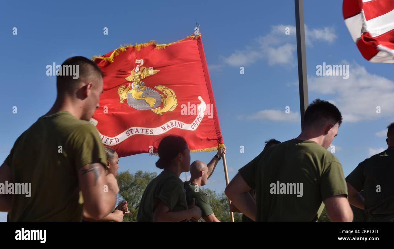 A Marine carries the guidon during a moto-run at Goodfellow Air Force ...
