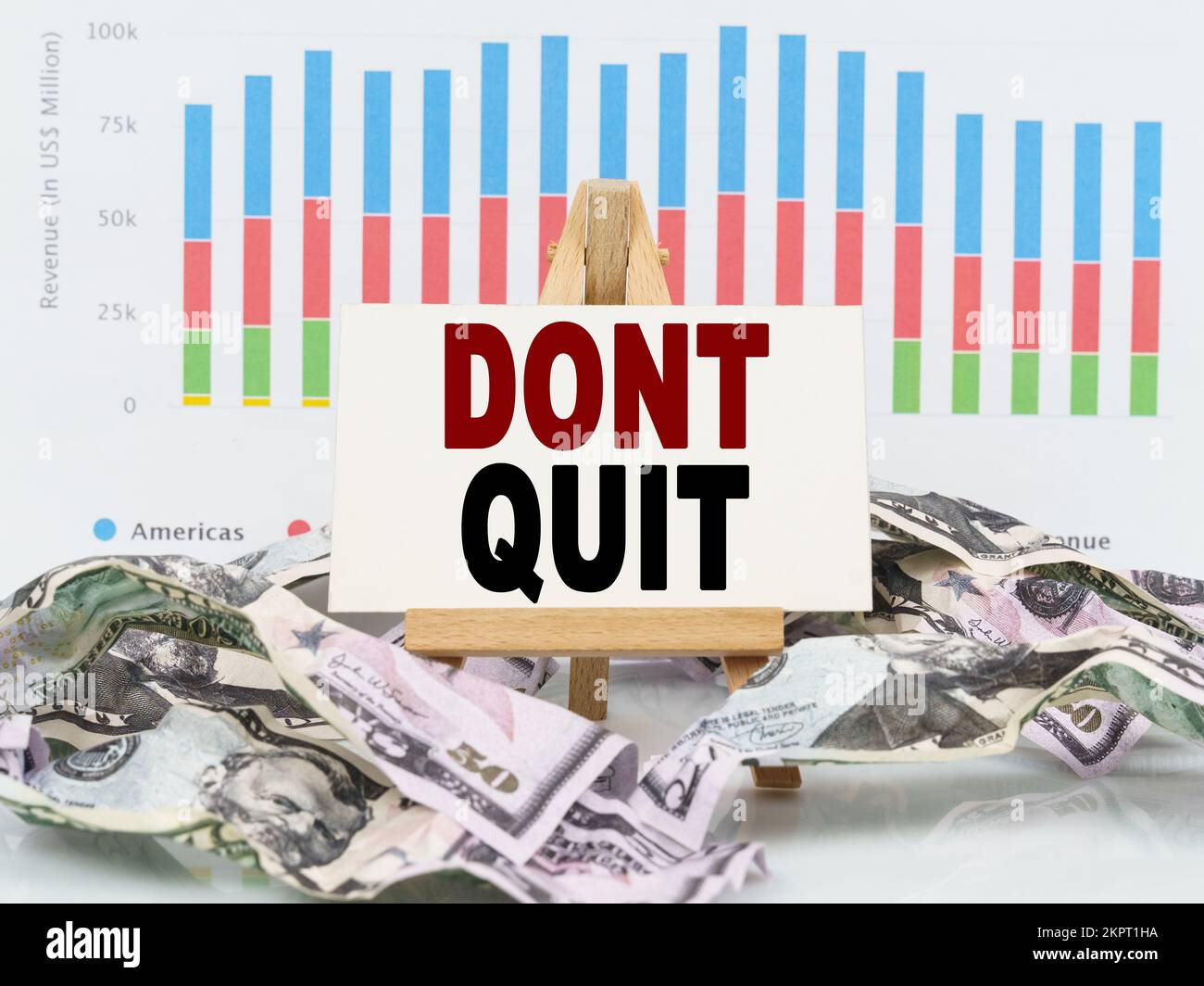 Business and finance concept. Among financial charts and money is a ...