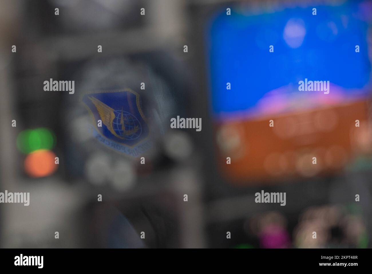 A Pacific Air Forces patch reflects in the instruments of a KC-135 ...