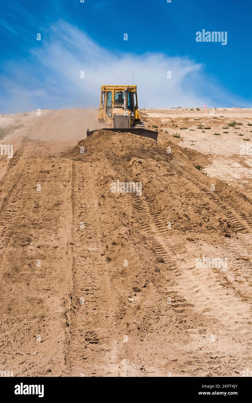 Caterpillar heavy equipment working at an active landfill in dusty ...