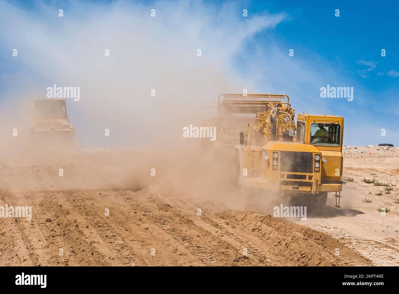 Caterpillar heavy equipment working at an active landfill in dusty ...