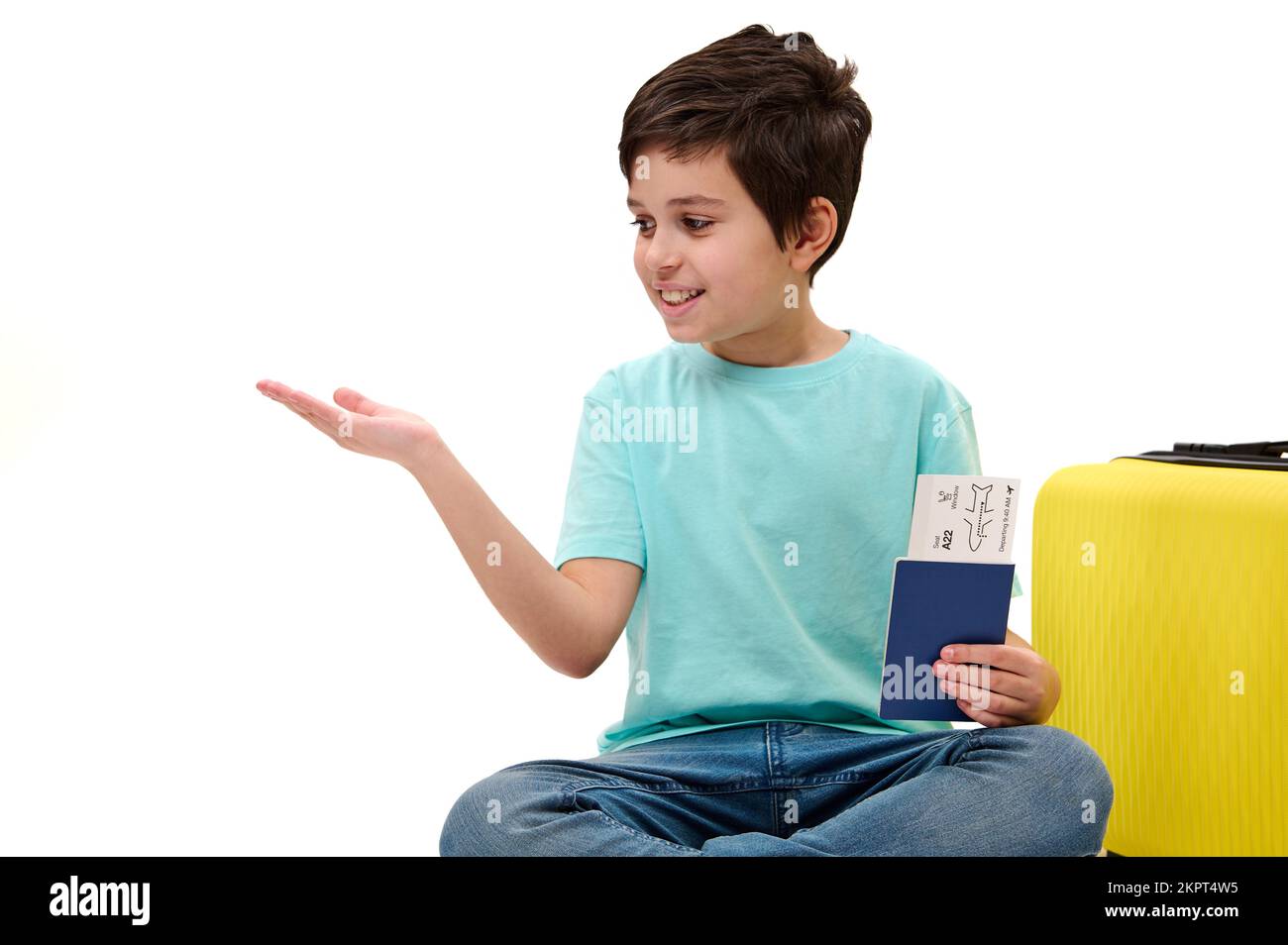 Teenage traveler boy in casual clothes with boarding pass, looking at ...