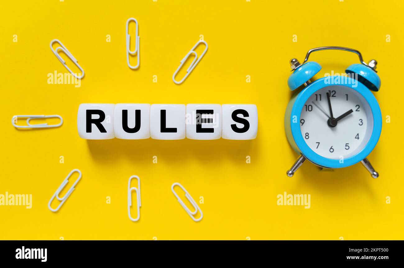 Finance and economics concept. On a yellow background, a blue alarm ...