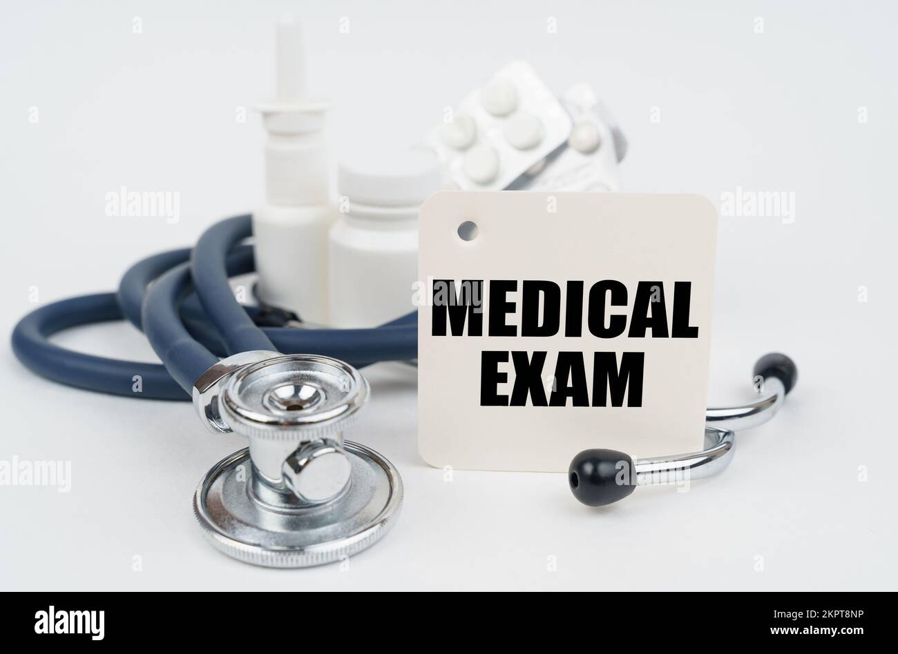 Medical concept. On a white surface, medicines, a stethoscope and ...